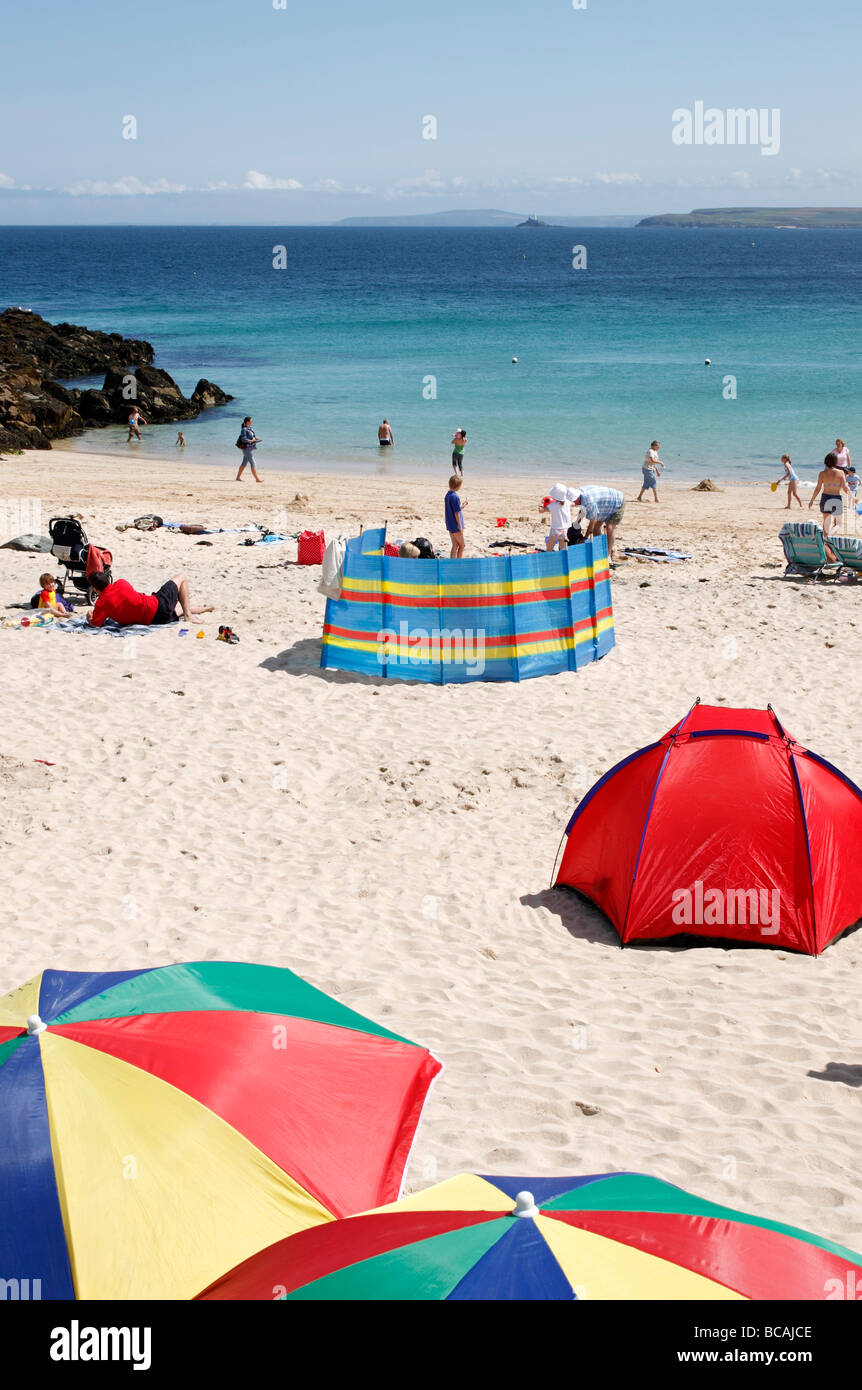 Porthgwidden beach in St. Ives, Cornwall England UK. Colourful brollies ...