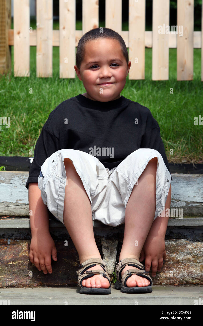 Happy latino boy sitting on outside steps Stock Photo - Alamy