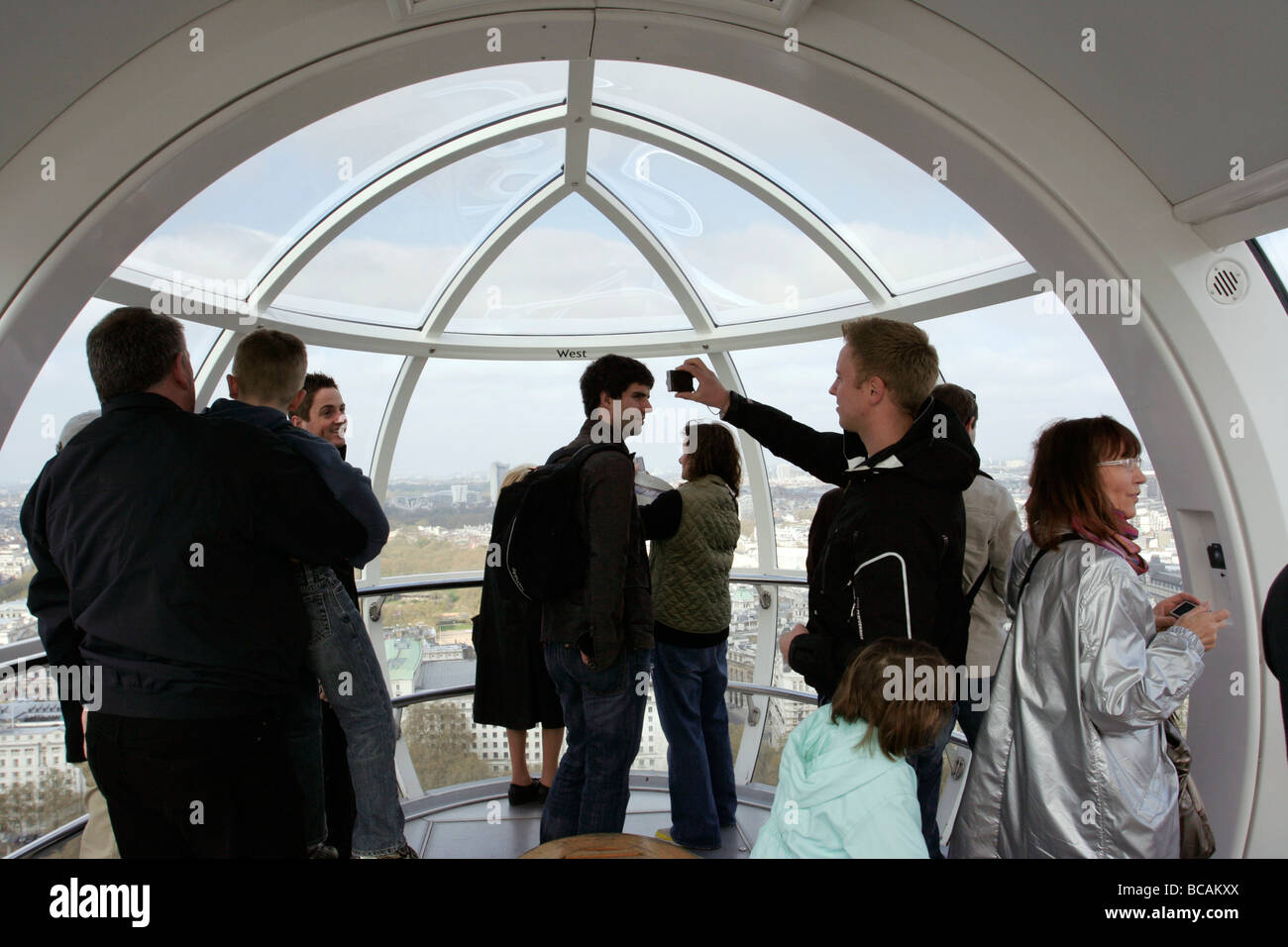 Tourists inside the capsule of London Eye Stock Photo - Alamy