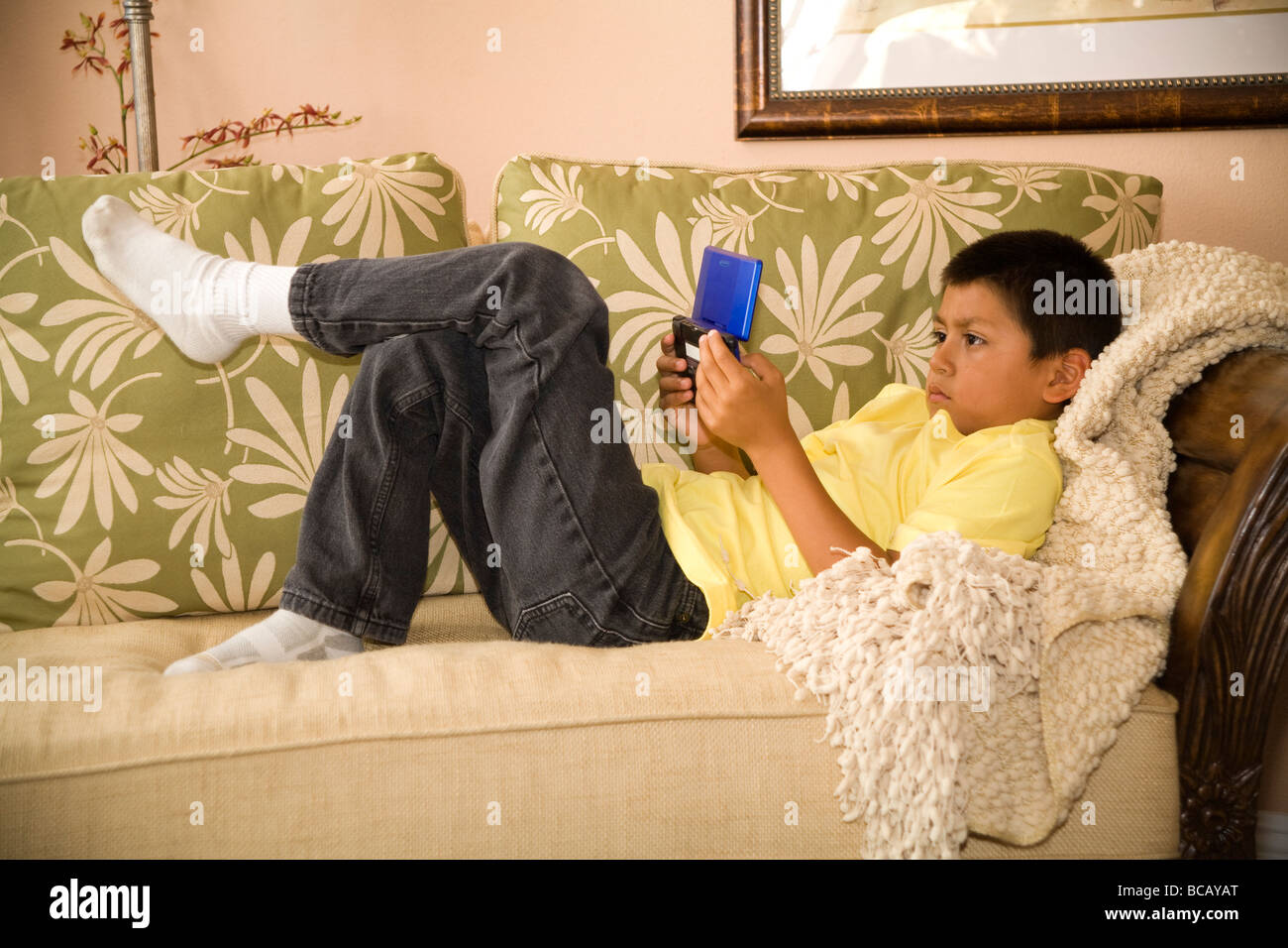 Hispanic boy playing Nintendo Gameboy DS MR Stock Photo - Alamy