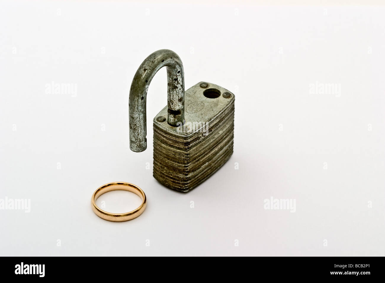 Open padlock with a gold wedding ring Stock Photo - Alamy