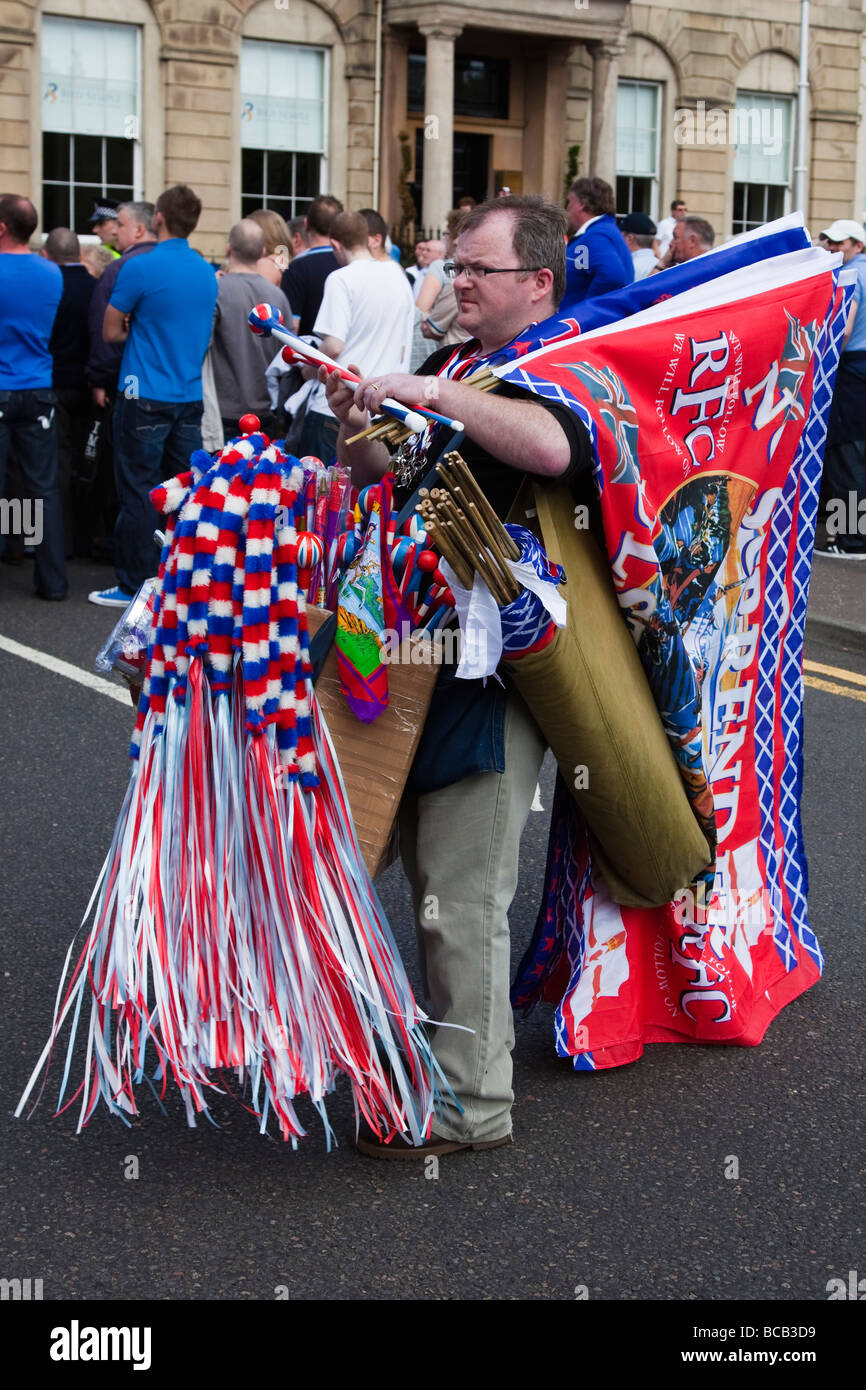 Street Vendor selling banners and flags at an Orange Walk Parade ...