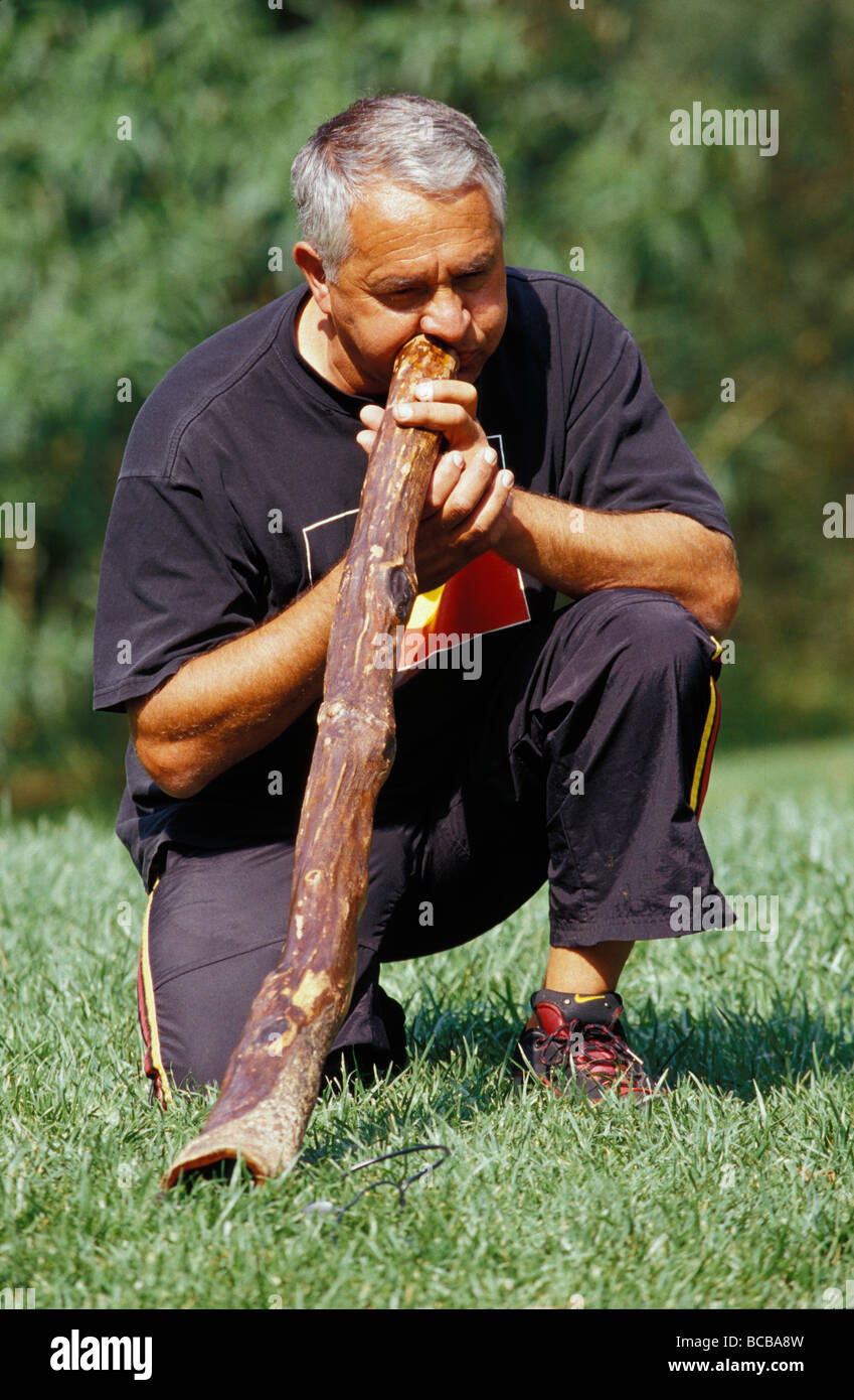 An Aboriginal Elder playing the diggeridoo, a wind instrument Stock ...