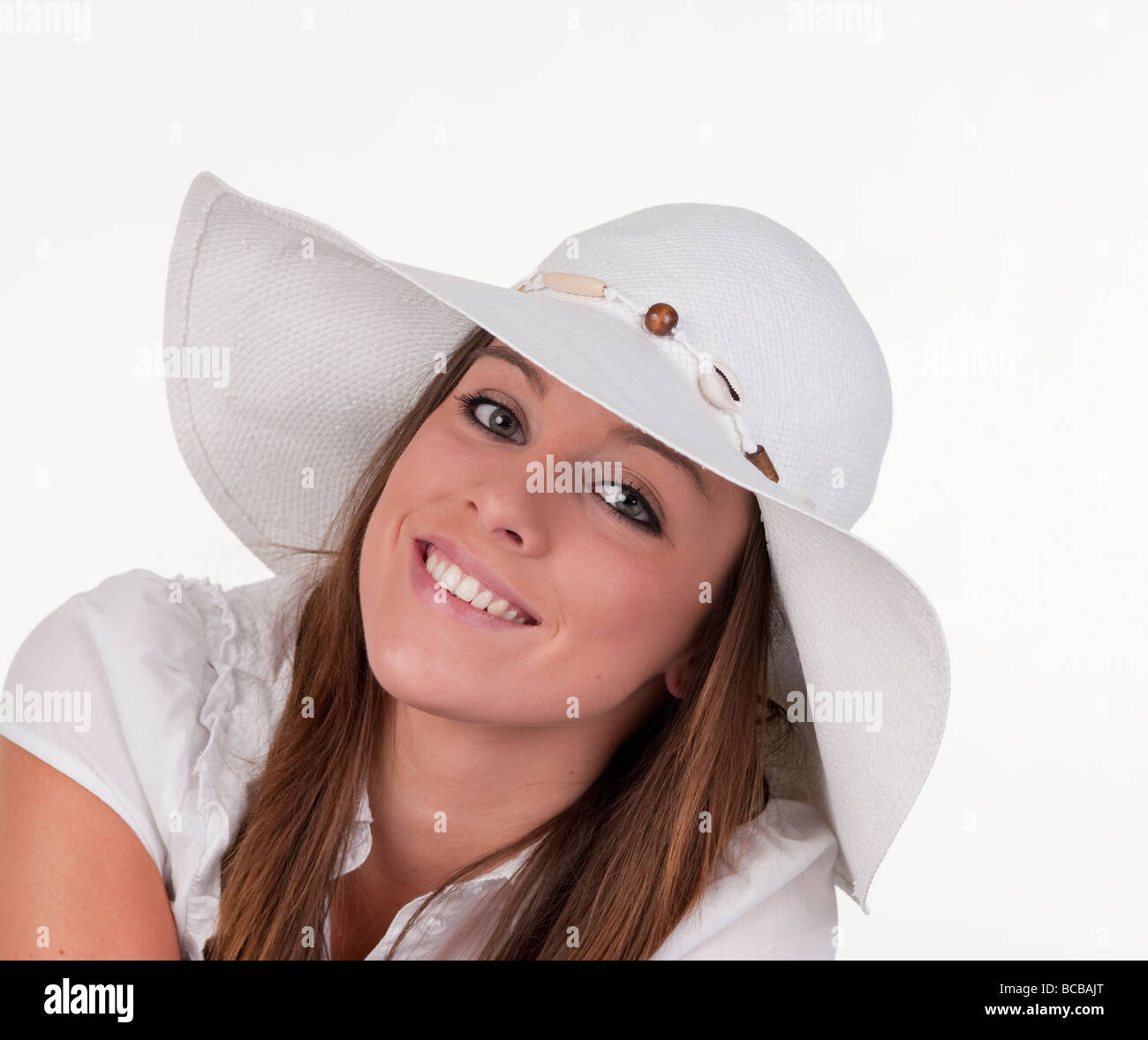 Attractive young woman with white hut isolated Stock Photo - Alamy
