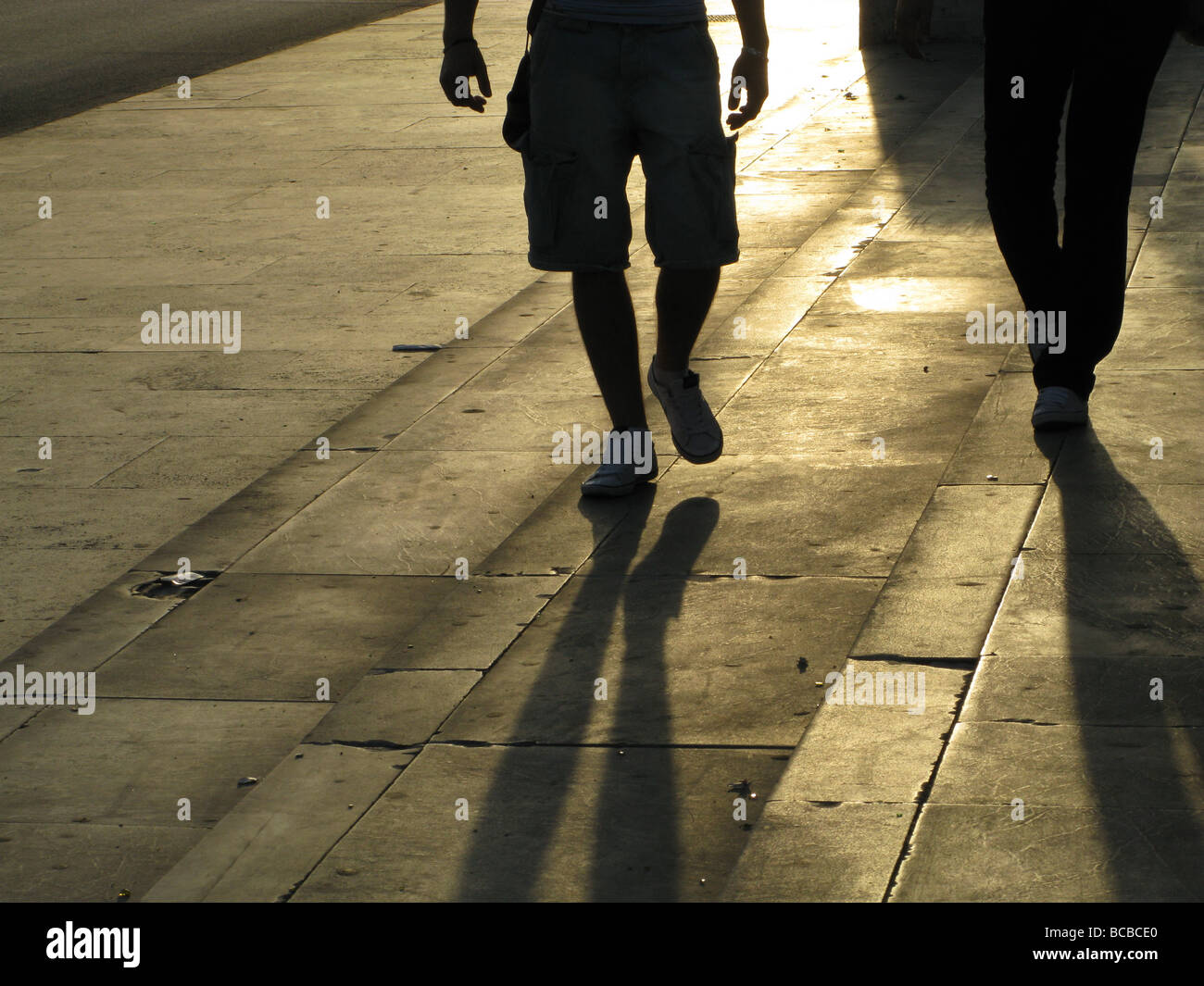 Two People Walking In The Street