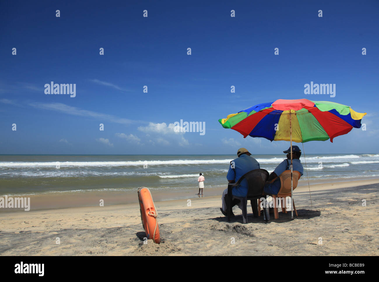 2 lifeguards sitting on Varkala beach Kerala India Stock Photo - Alamy