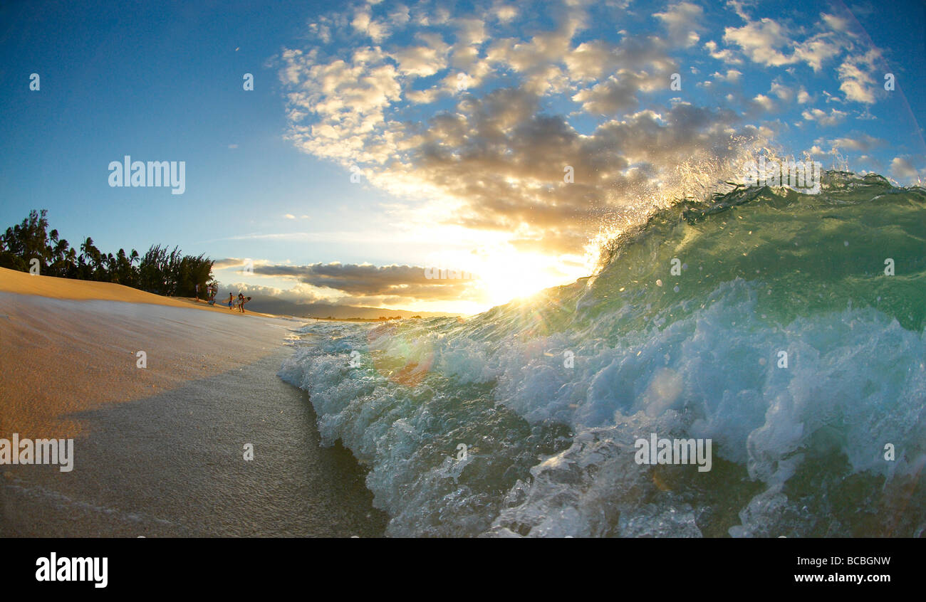 Wave crashing on beach Stock Photo - Alamy
