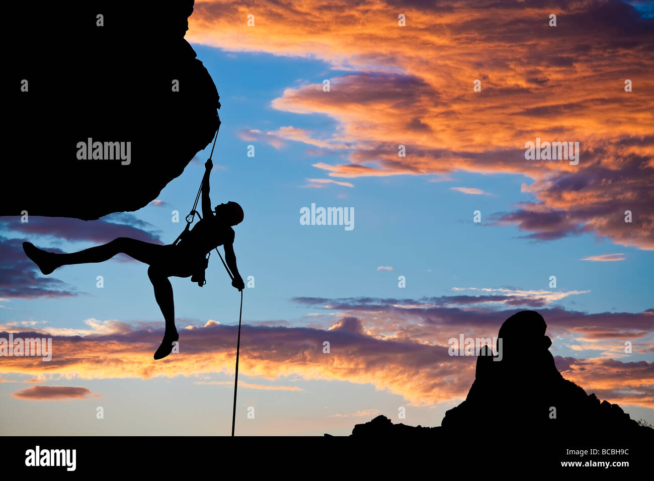 Silhouette rappelling from cliff hi-res stock photography and images ...