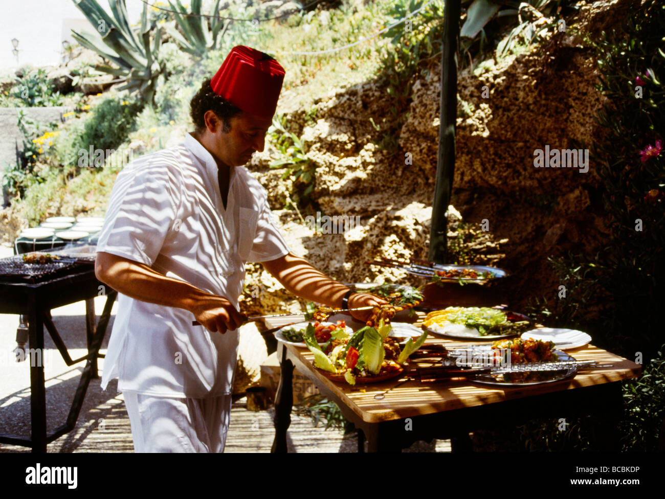 Arabian Sands Morocco Barbecue - Waiter Wearing Fez Hat Stock Photo - Alamy