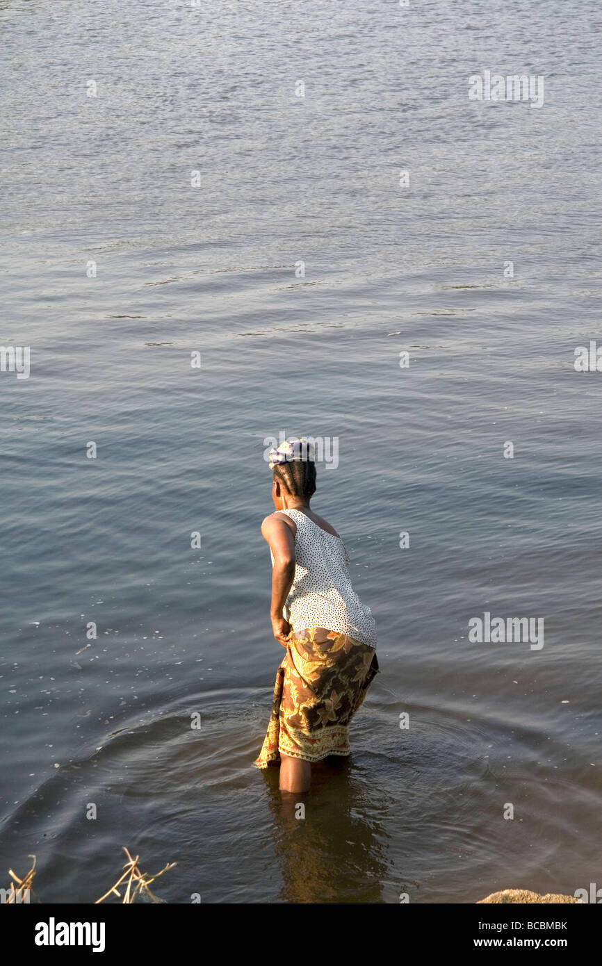 Woman fetching water from River Wouri at Bonendale village near Douala ...