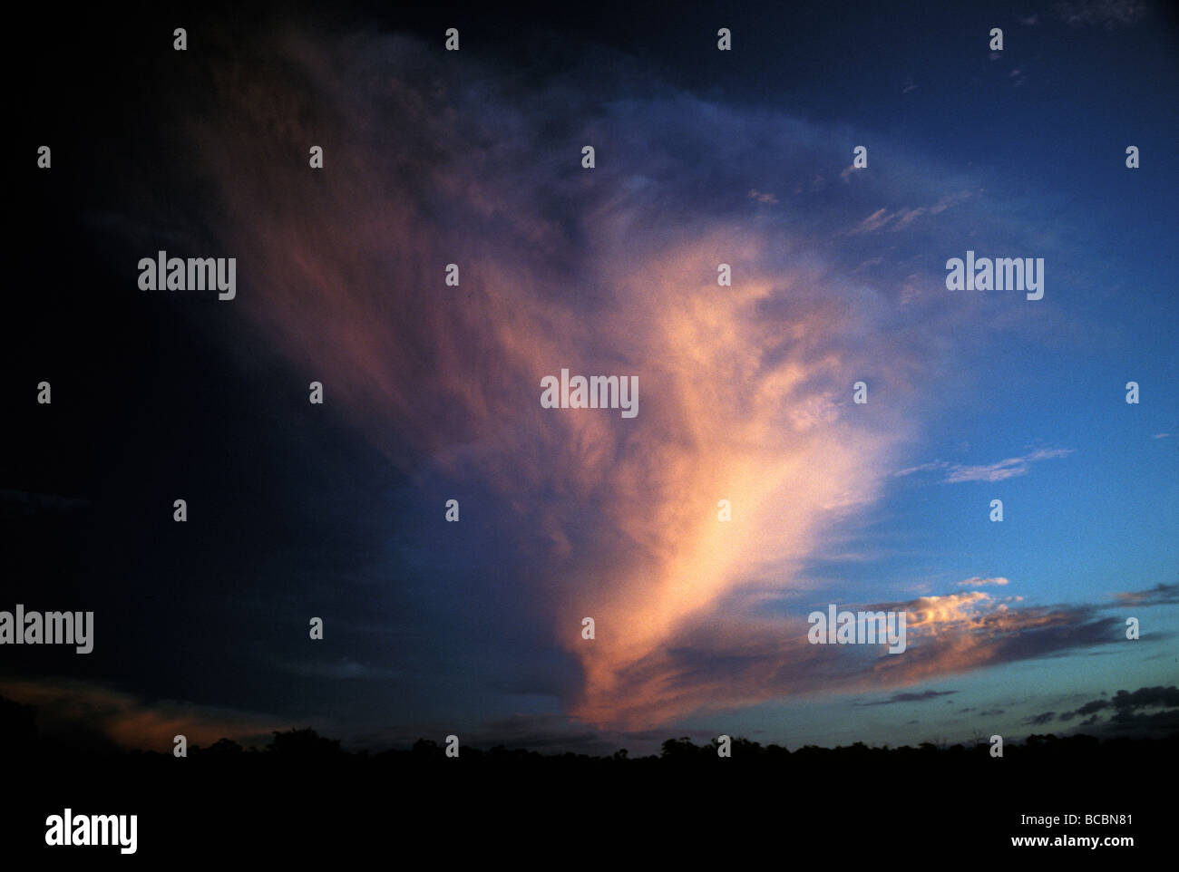 The rising sun reflects pink onto an unusual cloud formation Stock ...