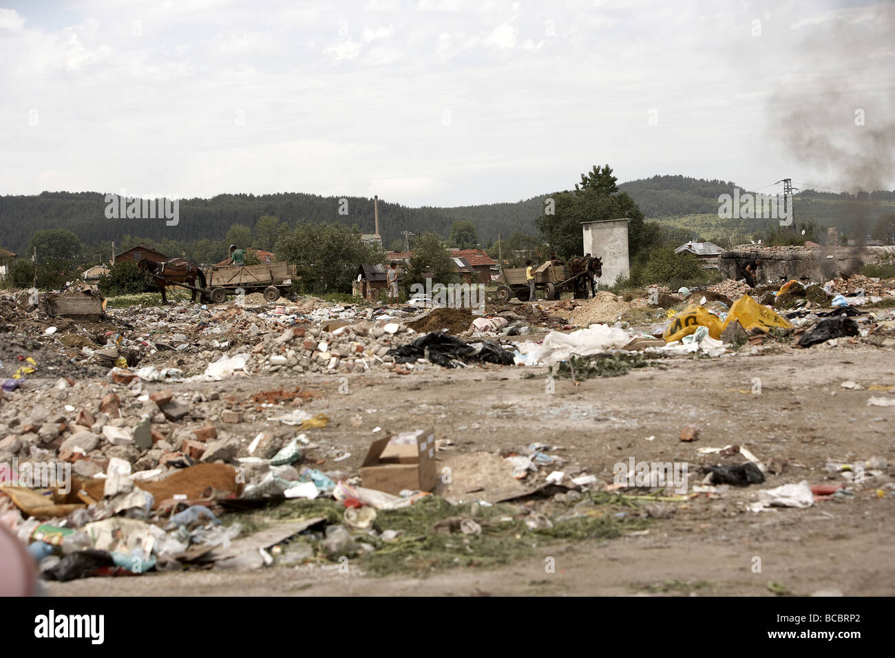 Adults and children scavenging for rubbish using a horse and cart ...