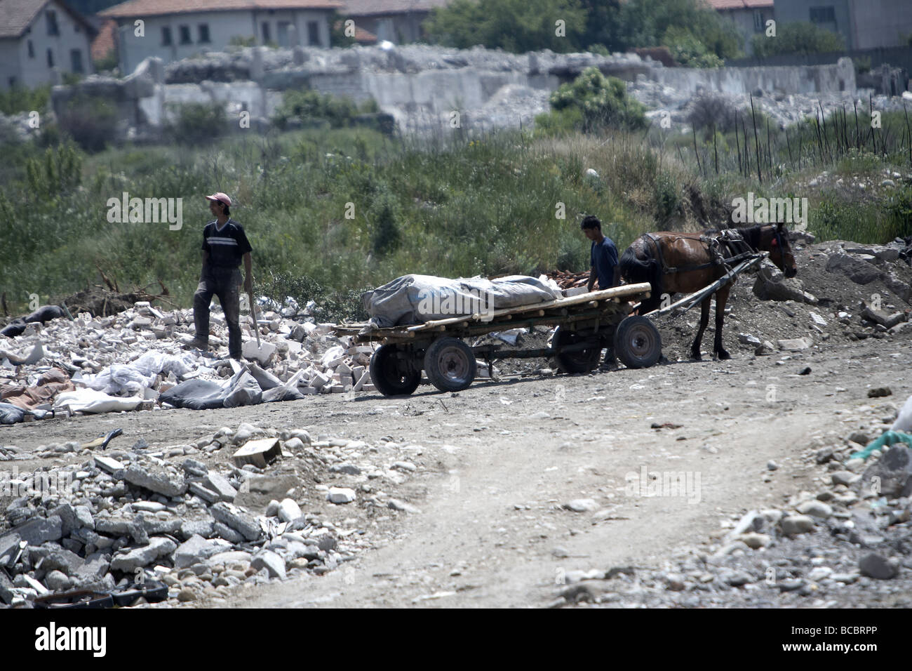 Adults and children scavenging for rubbish using a horse and cart ...