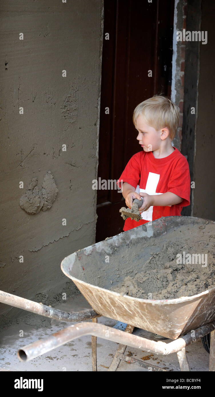 Little child blond boy playing with mortar Stock Photo - Alamy