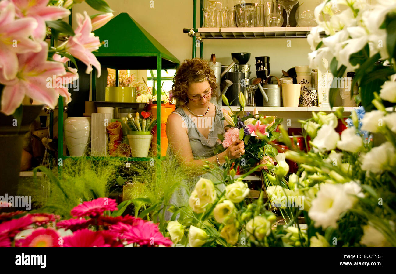 A florist selecting flowers for a bouquet in a french flower shop Stock ...