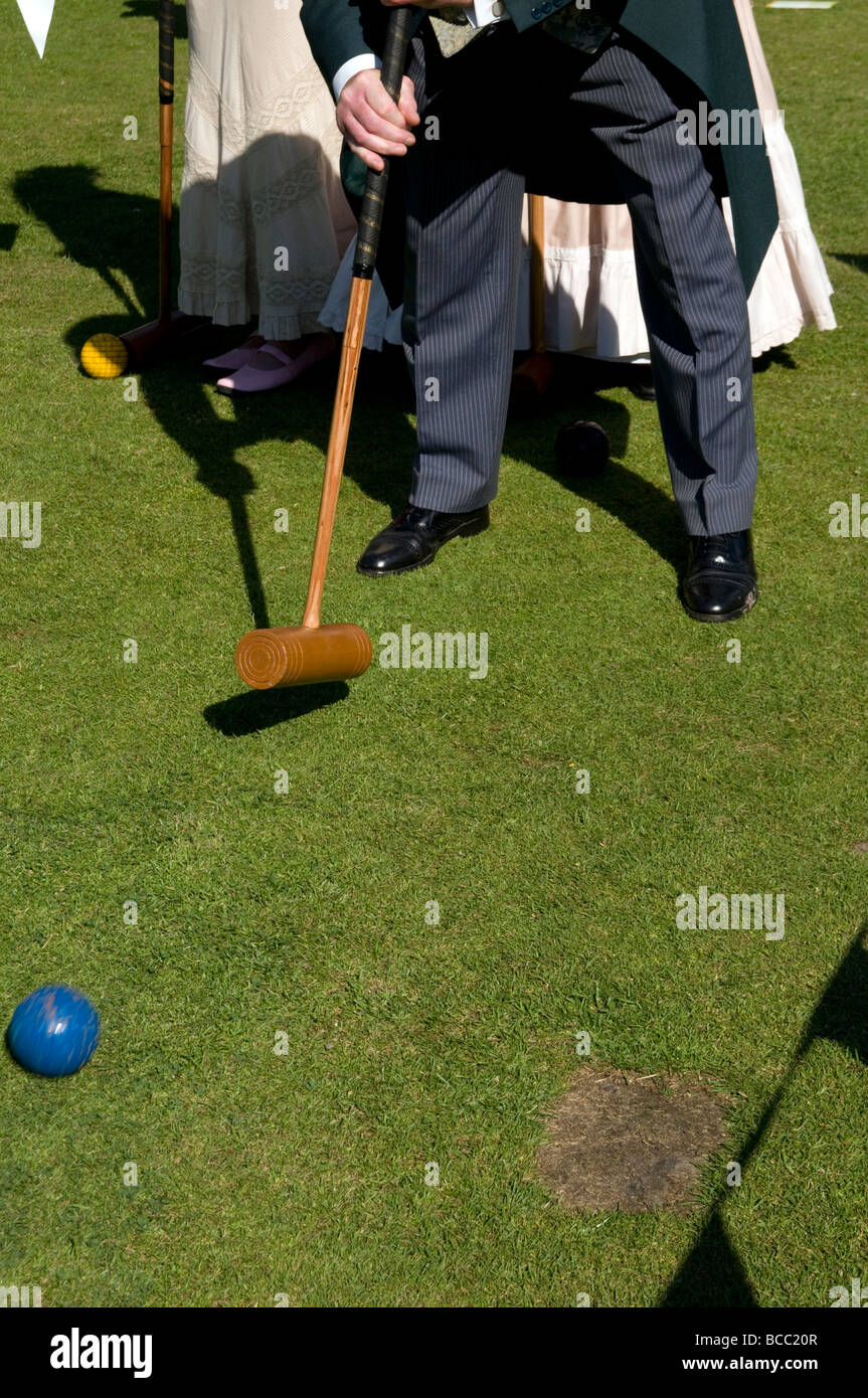 People dressed in Victorian clothes playing the lawn game of croquet in a park in Sheffield ...