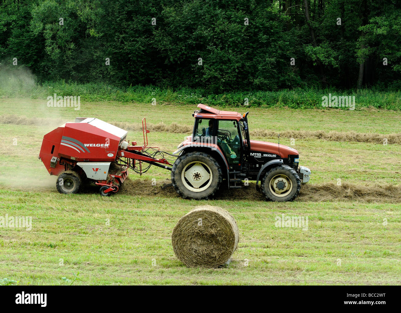 Tractor making bales of hay Stock Photo - Alamy