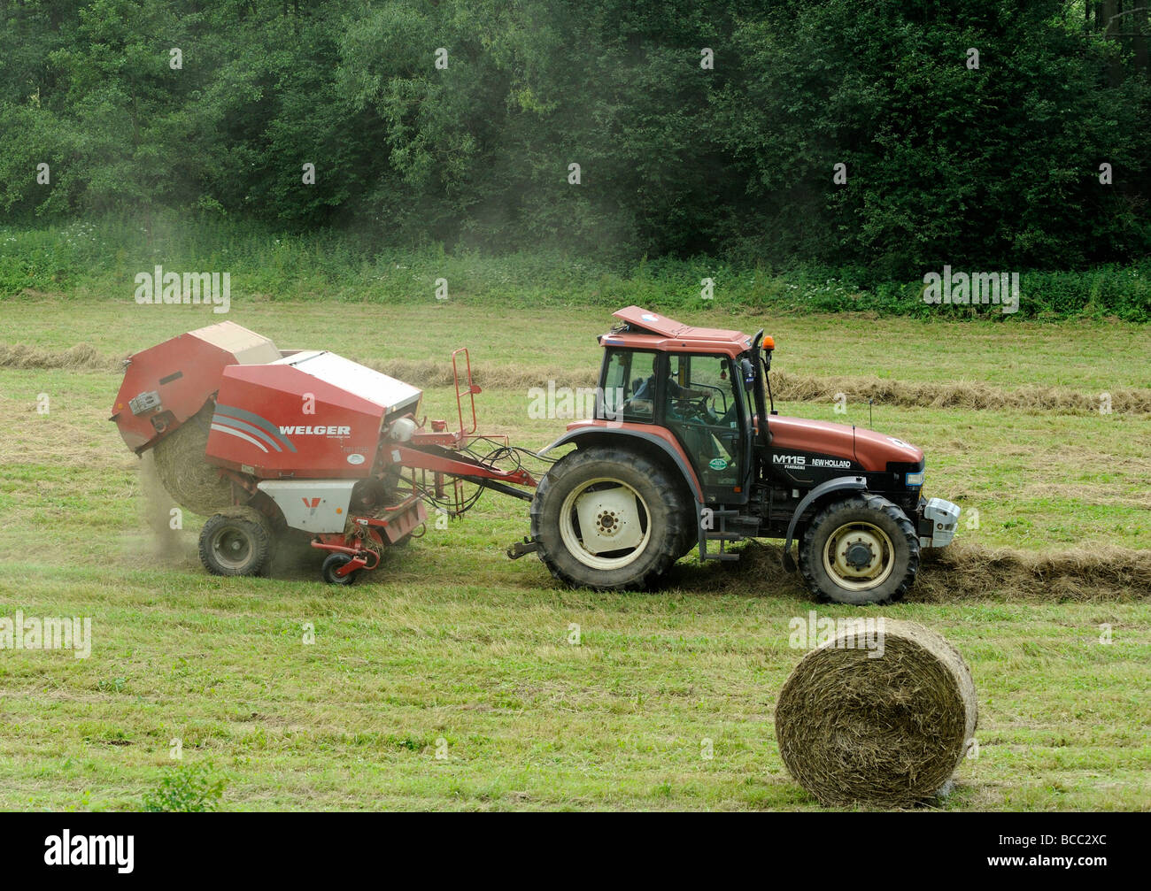 Tractor making bales of hay Stock Photo - Alamy