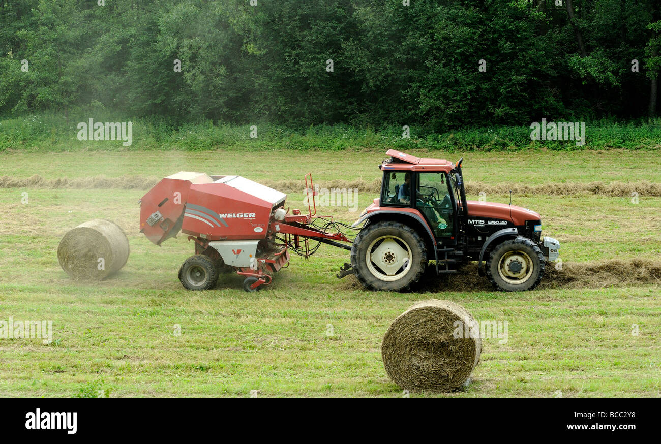 Tractor making bales of hay Stock Photo - Alamy