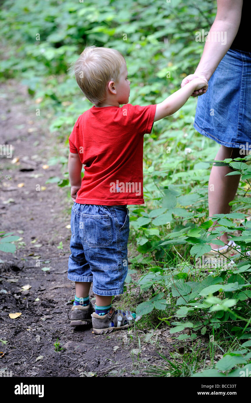 Little child blond Boy Eating Blueberries with mother in forest Stock ...