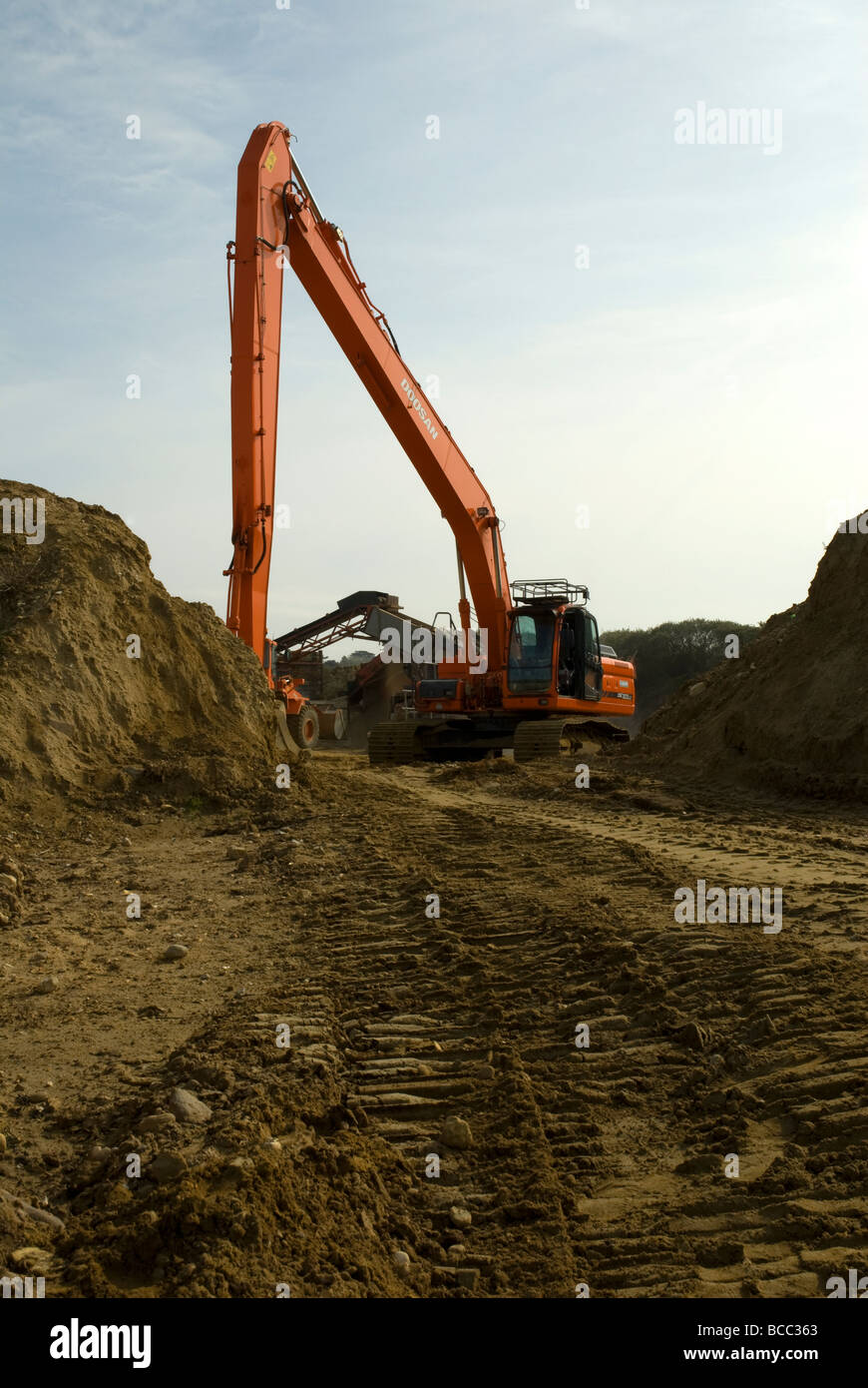 An excavtor digging sand Stock Photo - Alamy