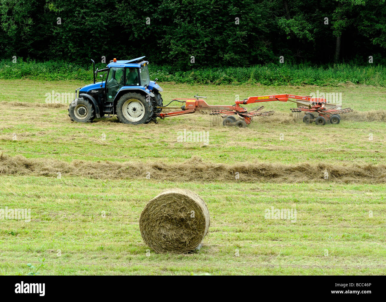 Tractor making bales of hay Stock Photo - Alamy