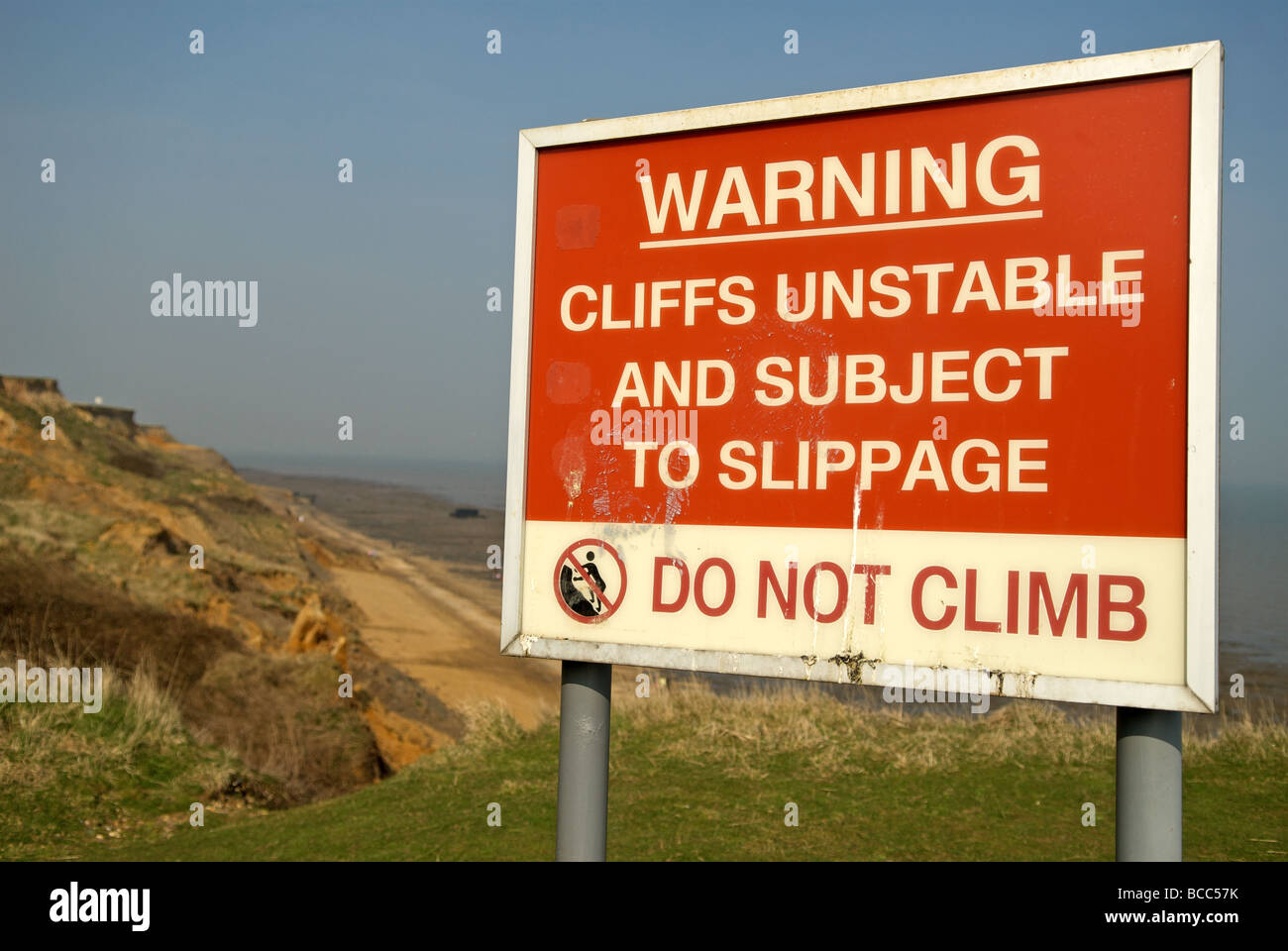 Warning sign of cliffs subject to slippage due to coastal erosion Stock ...