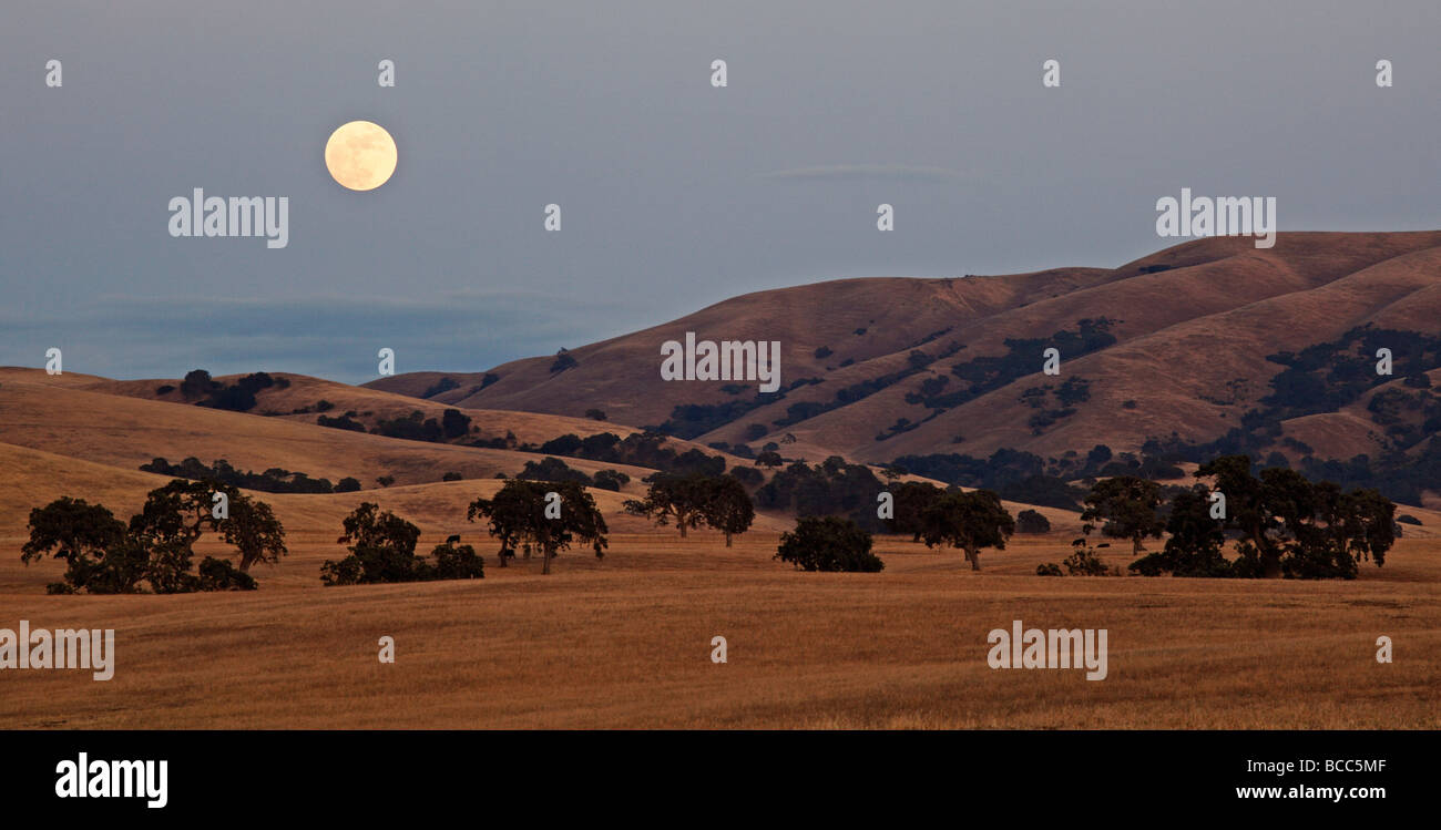 Moonrise over rolling hills Stock Photo - Alamy