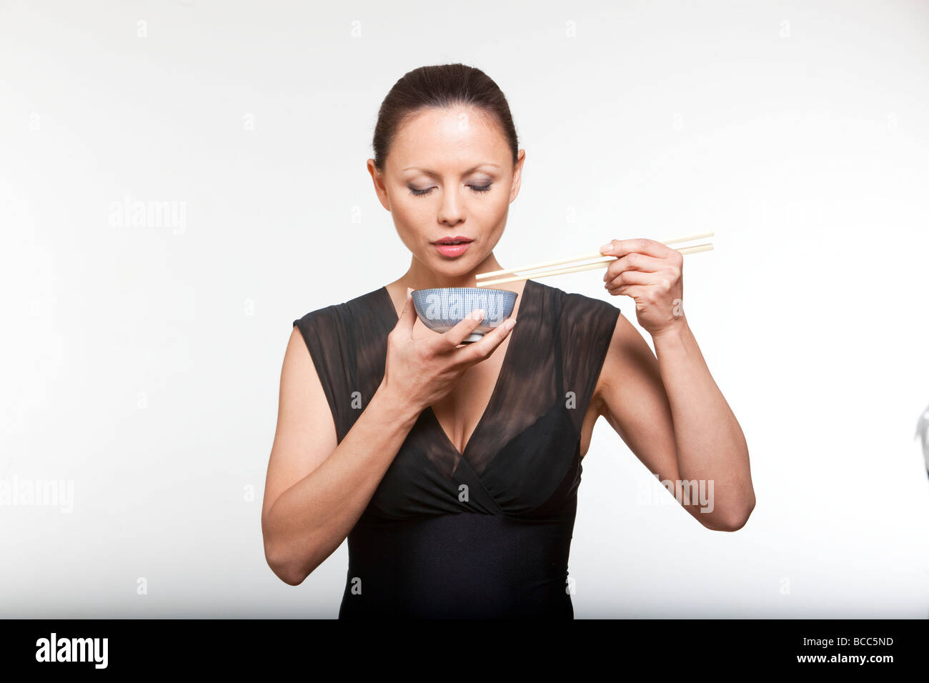 woman eating chopsticks studio bowl studio asian Stock Photo - Alamy