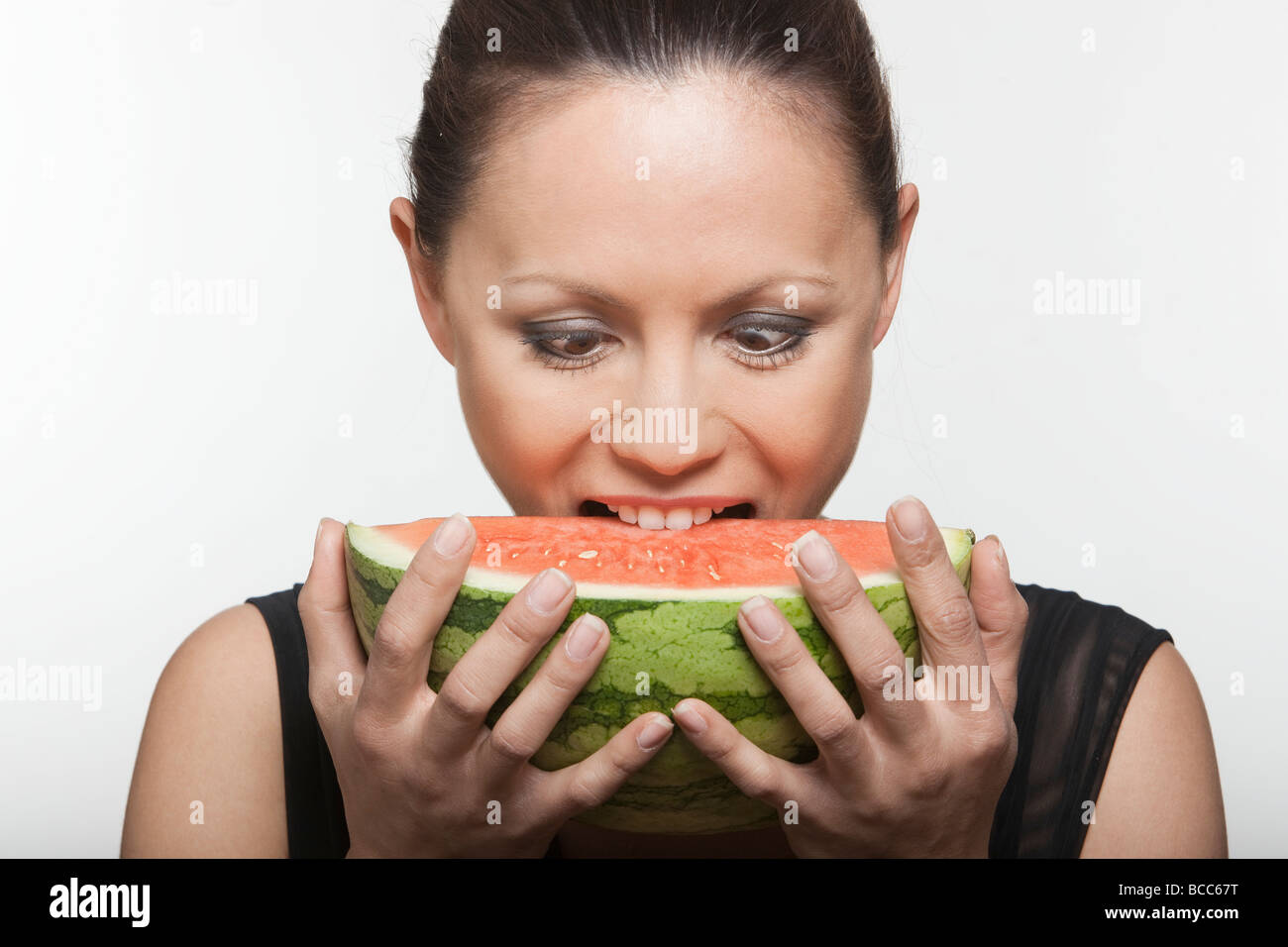 woman showing holding watermelon smiling studio Stock Photo - Alamy