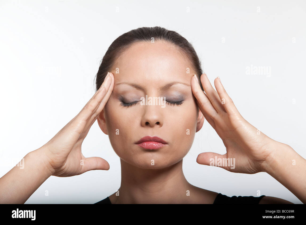 beautiful expressing woman portrait on isolated background massaging ...