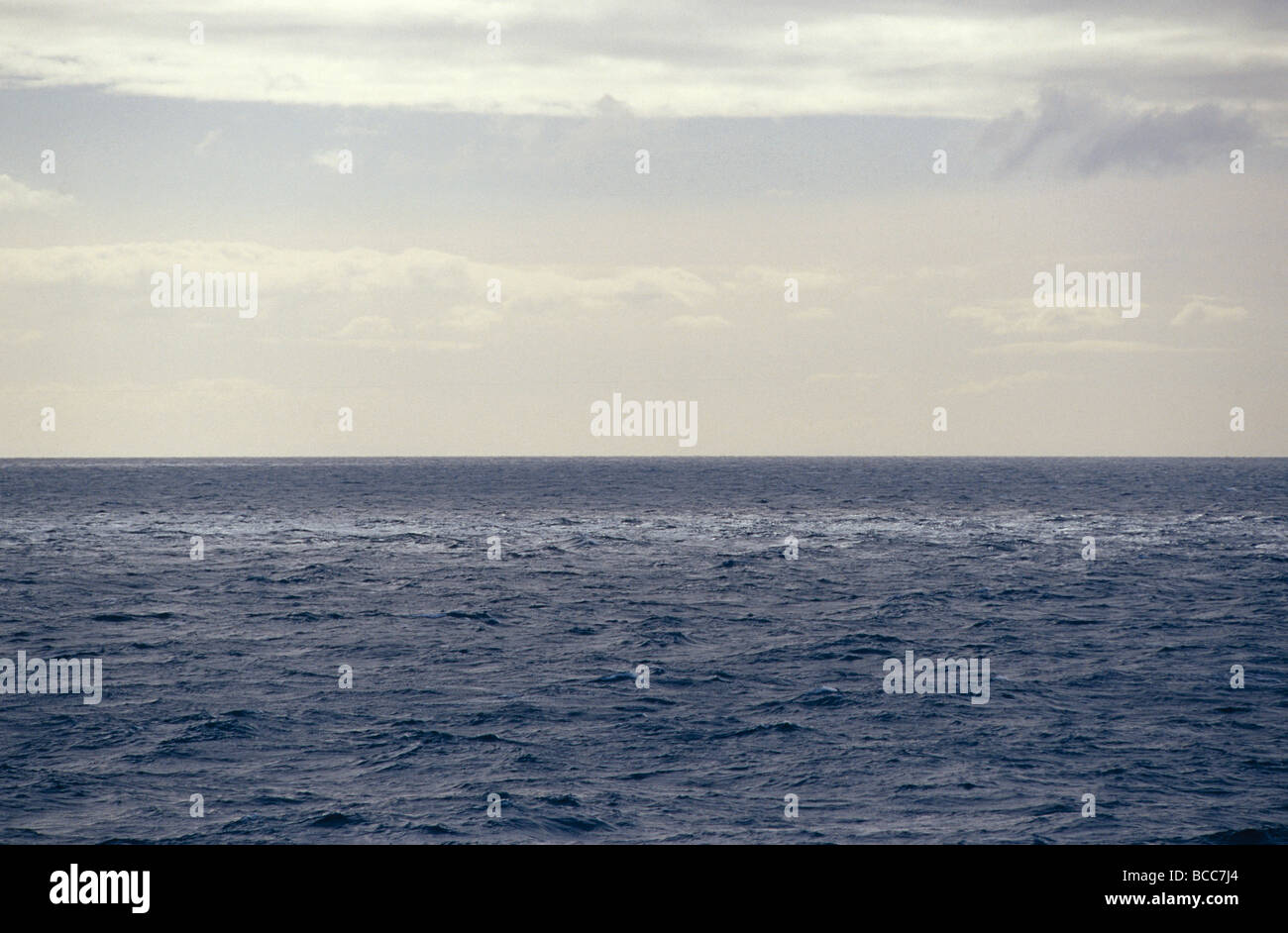 A calm, vast ocean in dappled shadow and light Stock Photo - Alamy