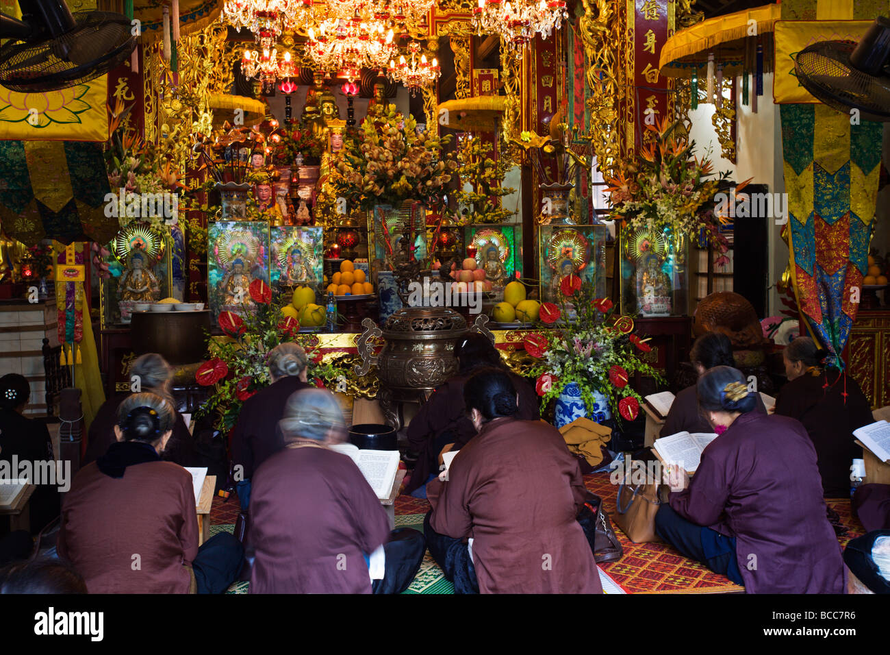 Women praying in the temple located next to One Pillar Pagoda inside ...