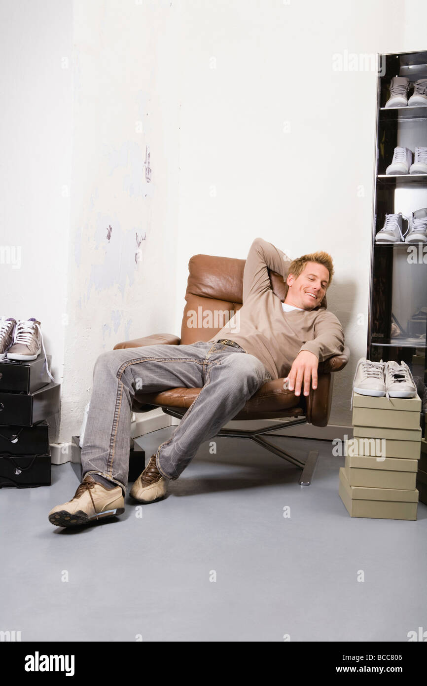 Young man in shoe store, relaxing Stock Photo - Alamy