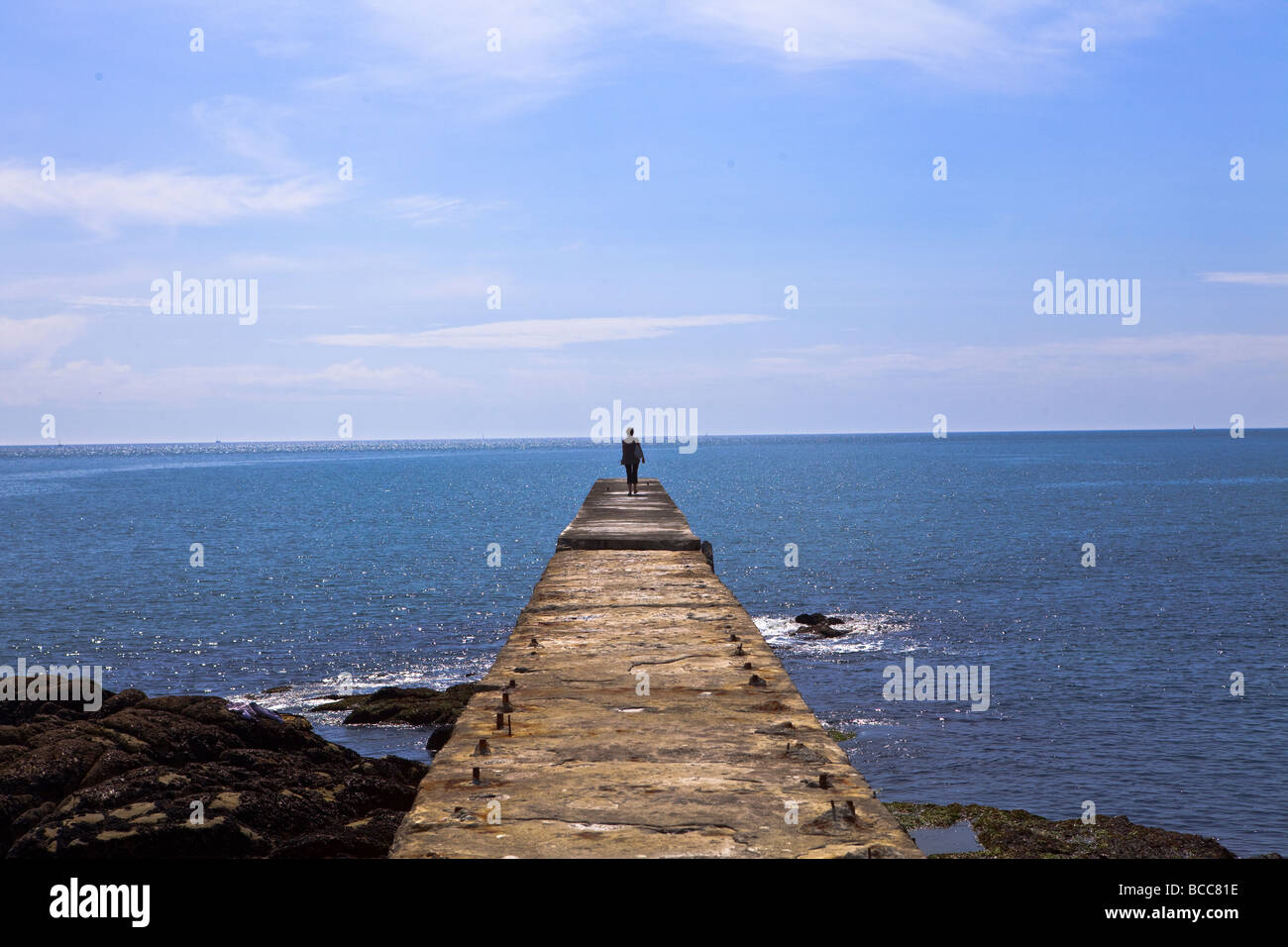 Woman on the jetty in the front of ocean. Brittany, France, Europe, EU ...