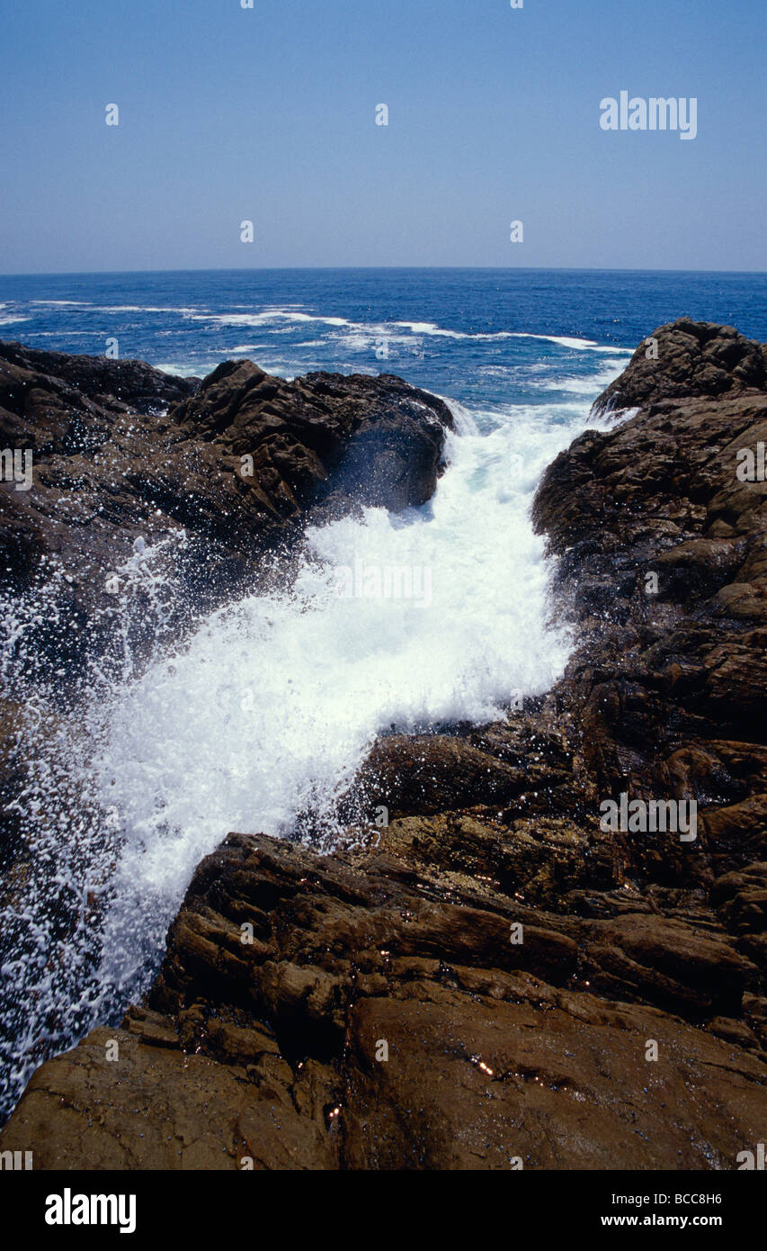 Ocean waves crashing onto rocks flow inland causing erosion Stock Photo ...