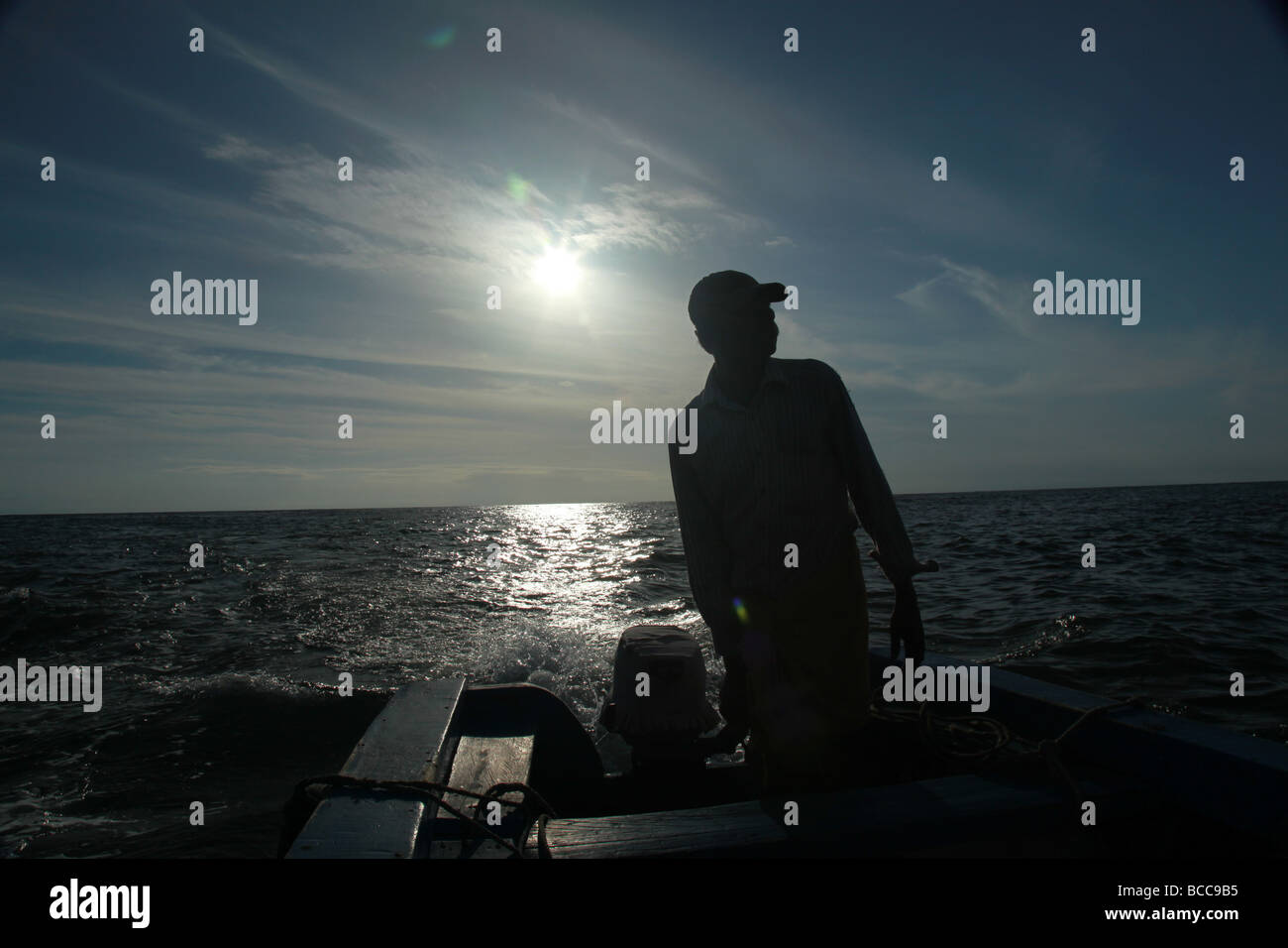 A fisherman fishing at night Stock Photo - Alamy