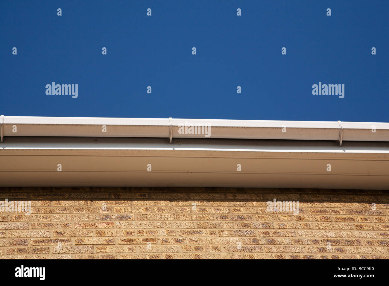 White PVC guttering on new London house Stock Photo - Alamy