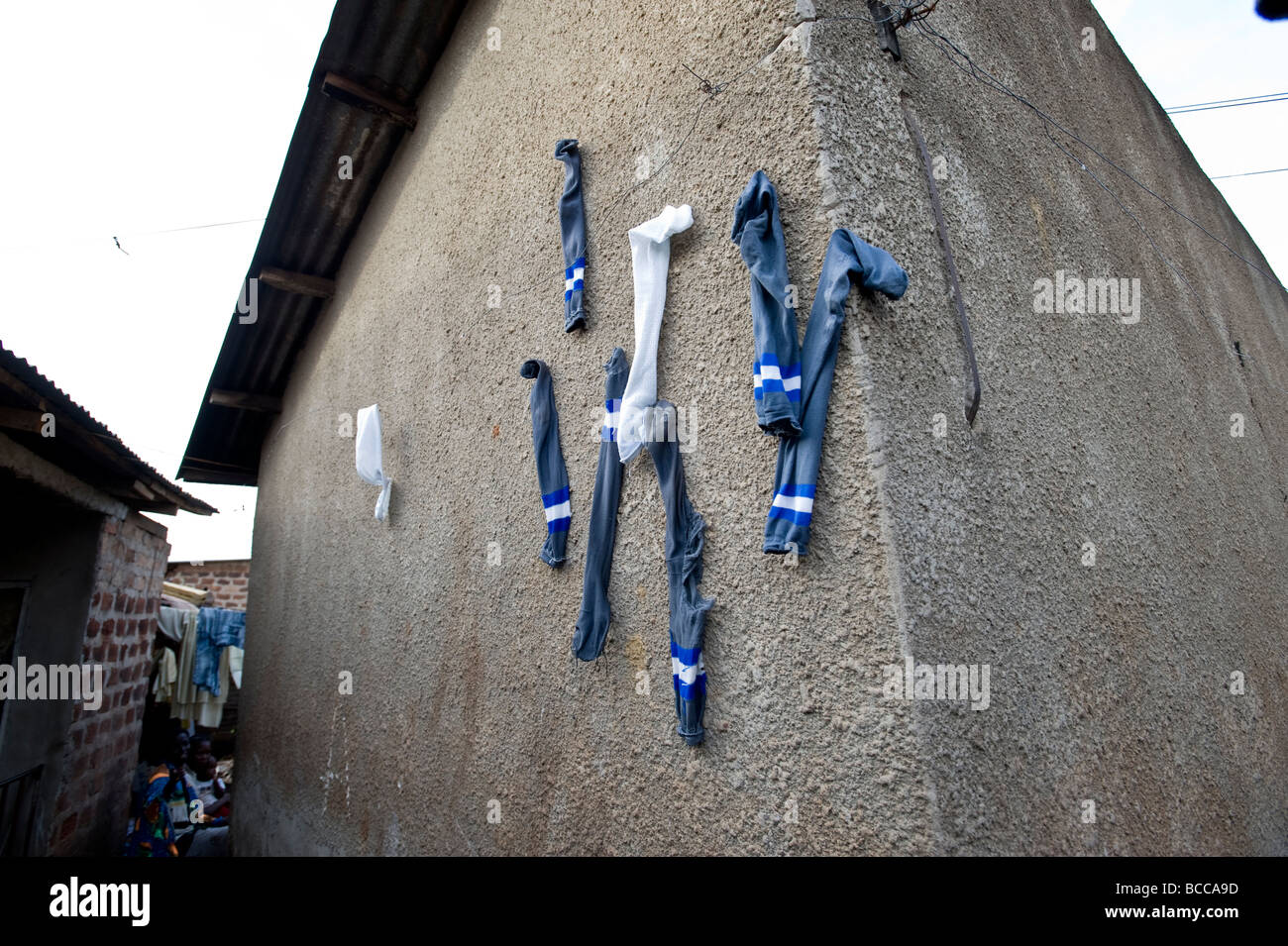 Blue and white school socks hung on wall to dry in Ugandan slum Stock ...