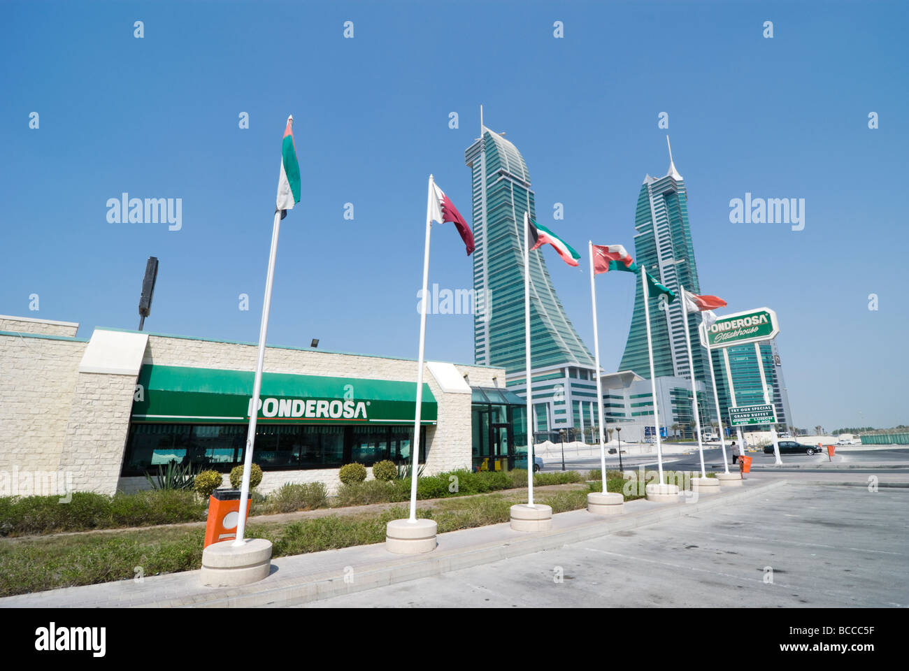 Trade Center Towers behind restaurant in Manama, Kingdom of Bahrain ...
