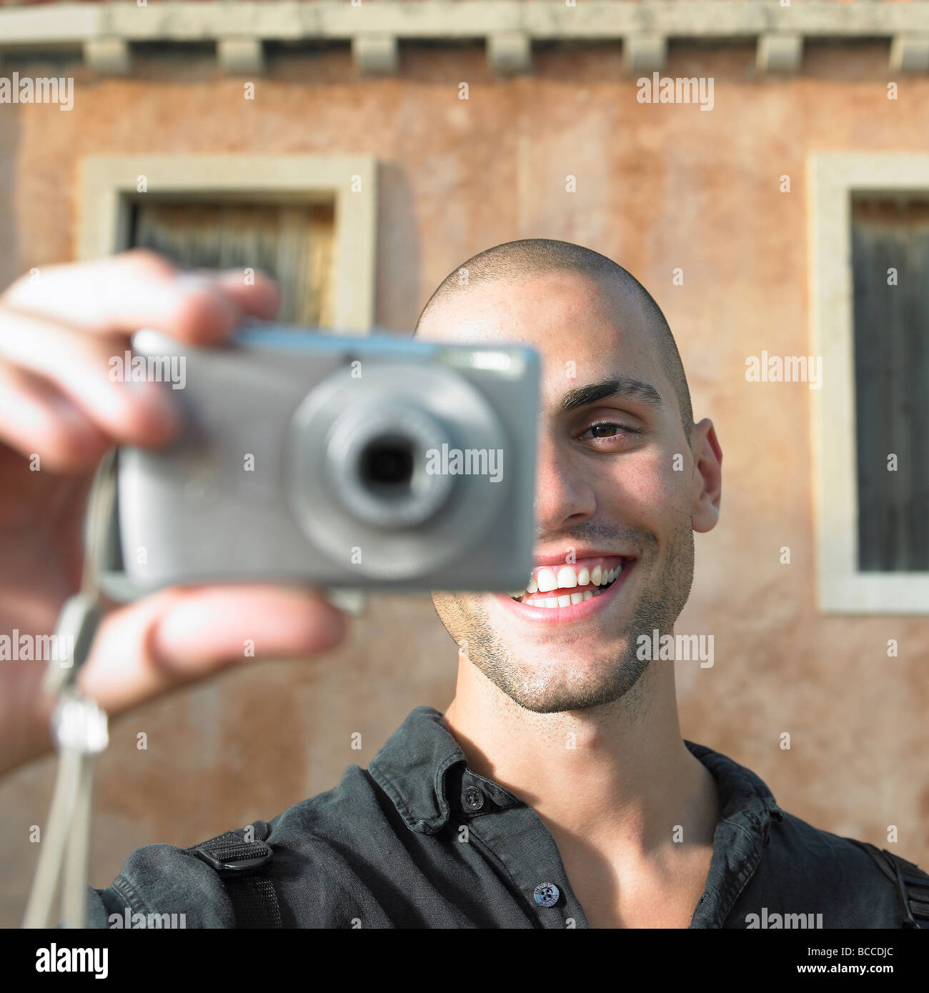 man using camera, smiling Stock Photo - Alamy