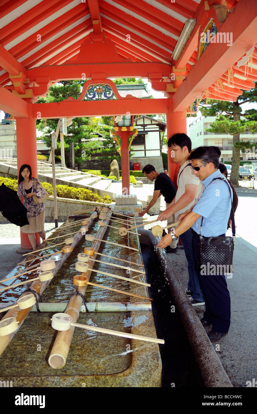 People washing hands at shinto temple, kyoto, japan Stock Photo - Alamy
