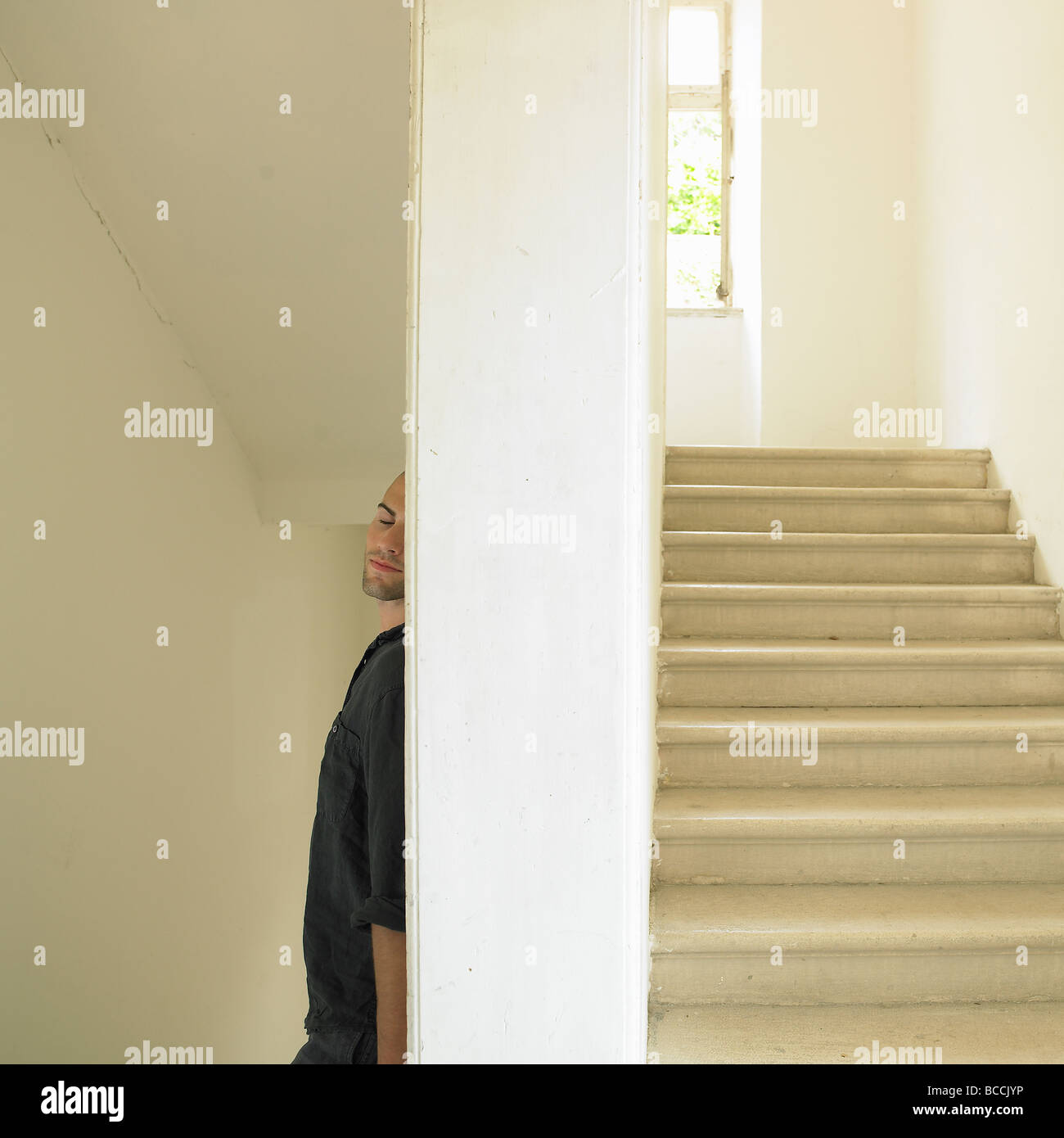 man standing behind wall Stock Photo - Alamy