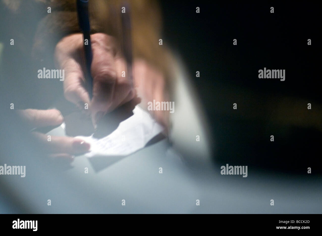 Hands of an old woman writing a note Stock Photo - Alamy