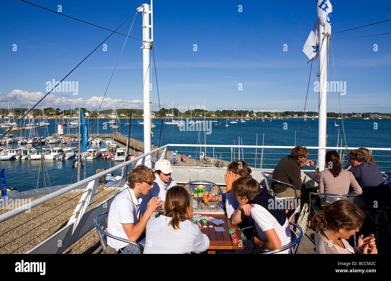 France, Morbihan, La Trinité sur Mer, terrace of a cafe above harbour ...