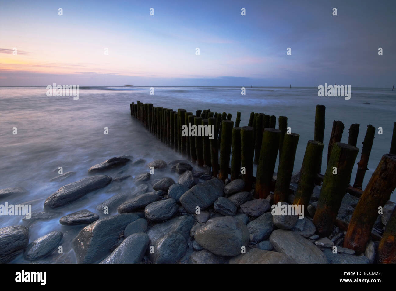 Atmospheric sunset over timber groynes on the North Devon coast at ...