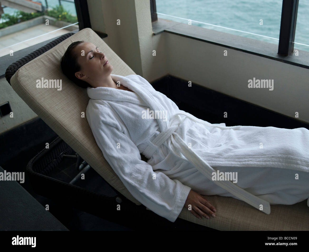 beautiful calm and serene woman in palace hotel room at the balcony ...