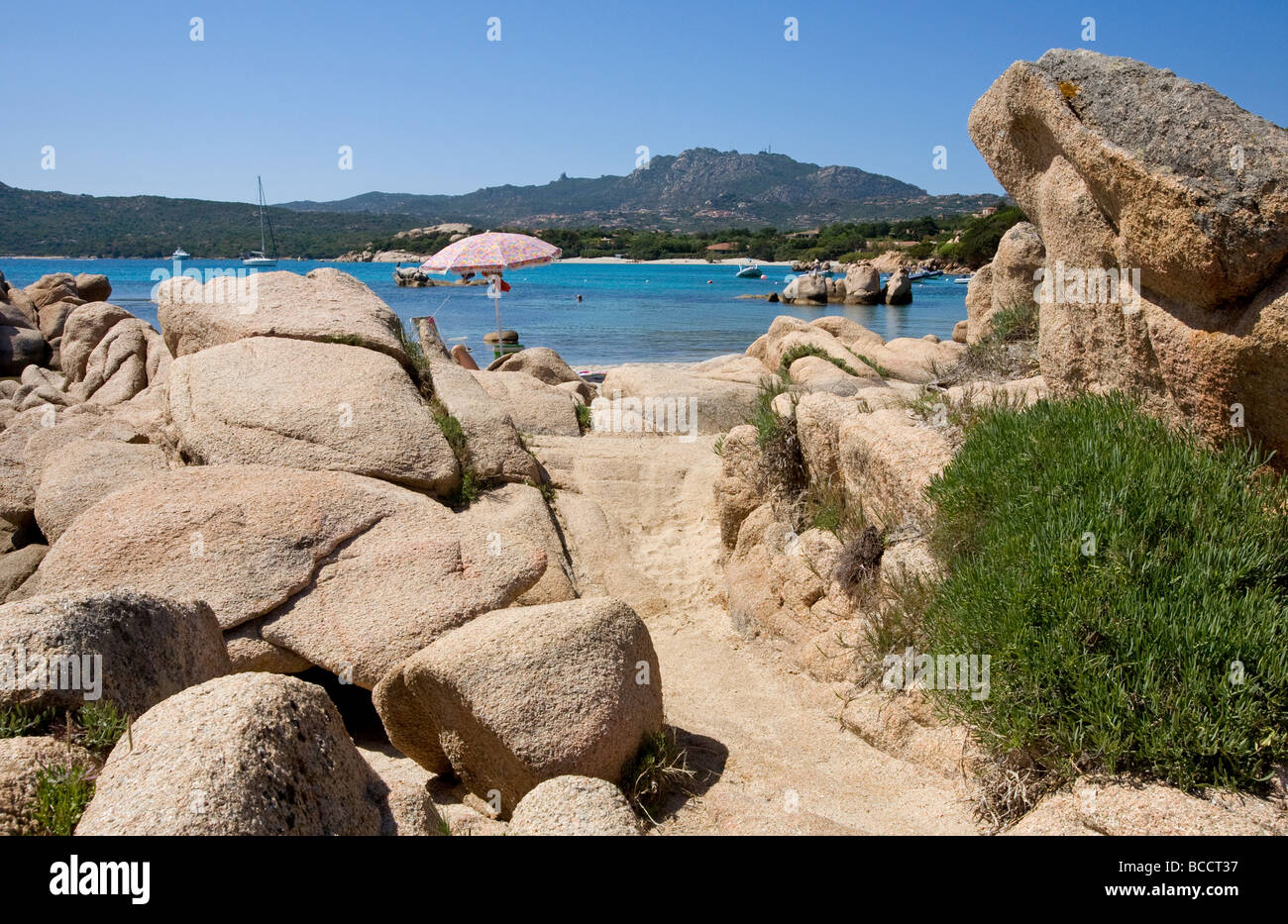 Pathway through large rocks at Capriccioli beach, Sardinia Stock Photo ...