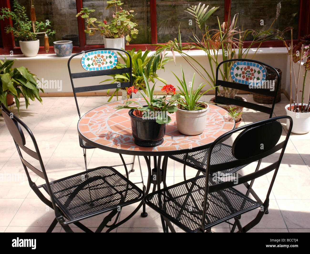 conservatory tables chairs plants room in house next to garden Stock ...