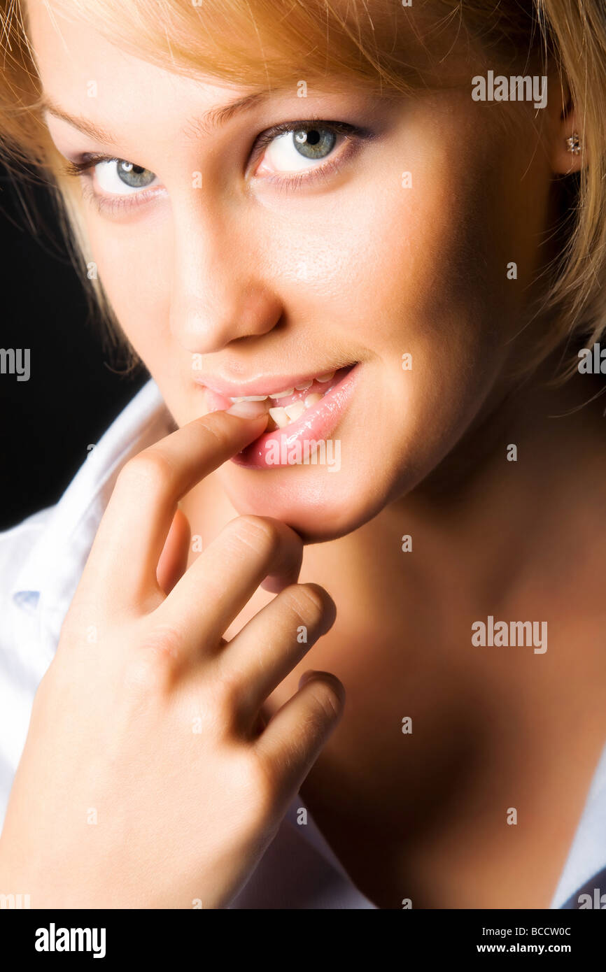 Young skittish woman On dark background Stock Photo - Alamy
